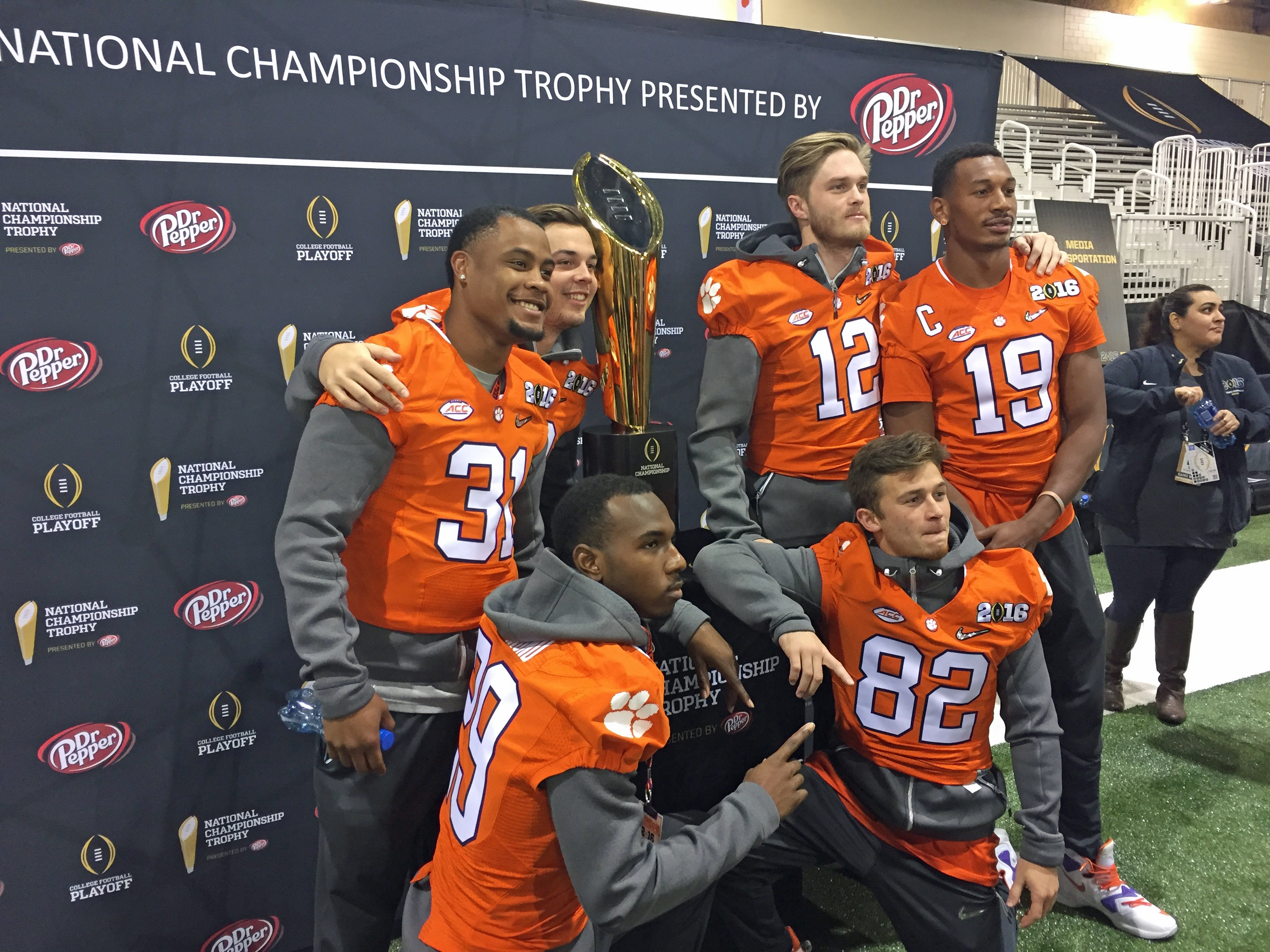 7. Clemson players with trophy – SportsTravel
